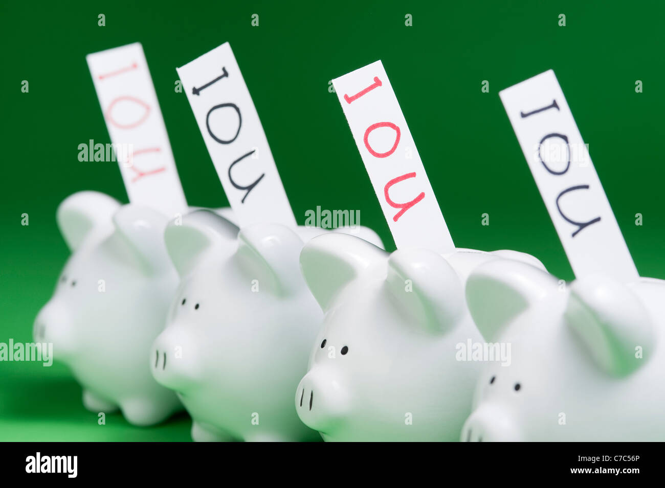 Group of piggy banks with IOU's coming out of coin slots Stock Photo ...