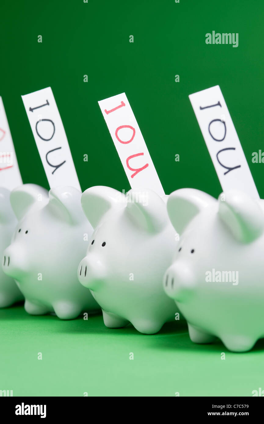 Group of piggy banks with IOU's coming out of coin slots Stock Photo ...