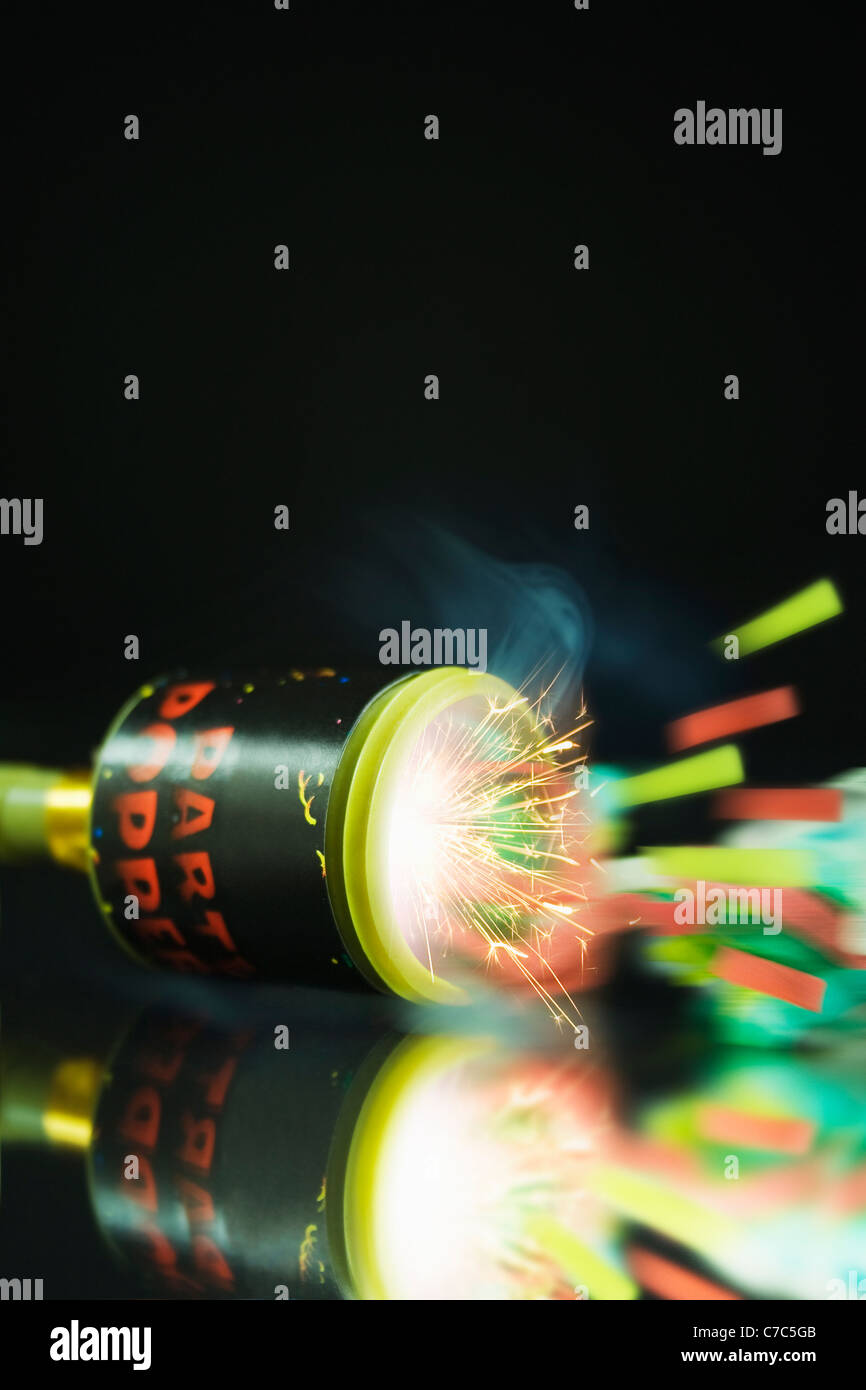 Close up shot of a Party Popper popping with sparks and streamers ...