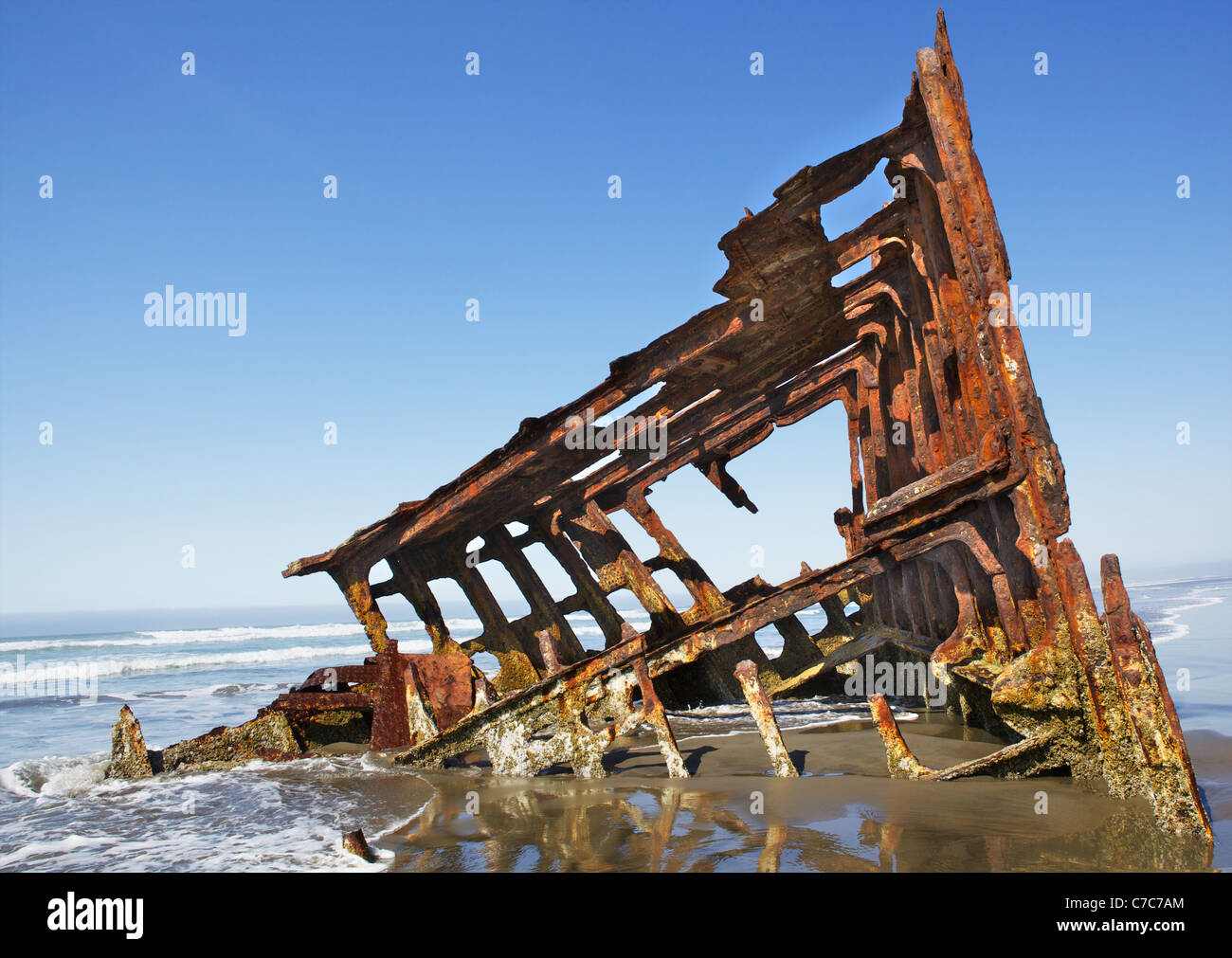 Red and green rusty steel of a shipwreck on an ocean beach Stock Photo ...