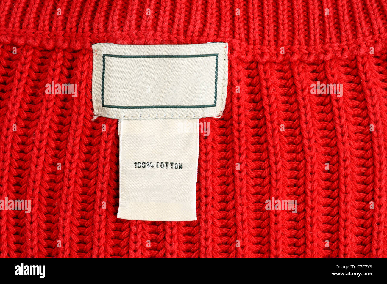 Clothing label inside of red sweater Stock Photo - Alamy