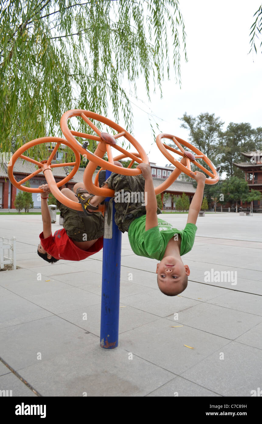 Two British children play on a 'street gym' in Zhangye, Gansu, China ...