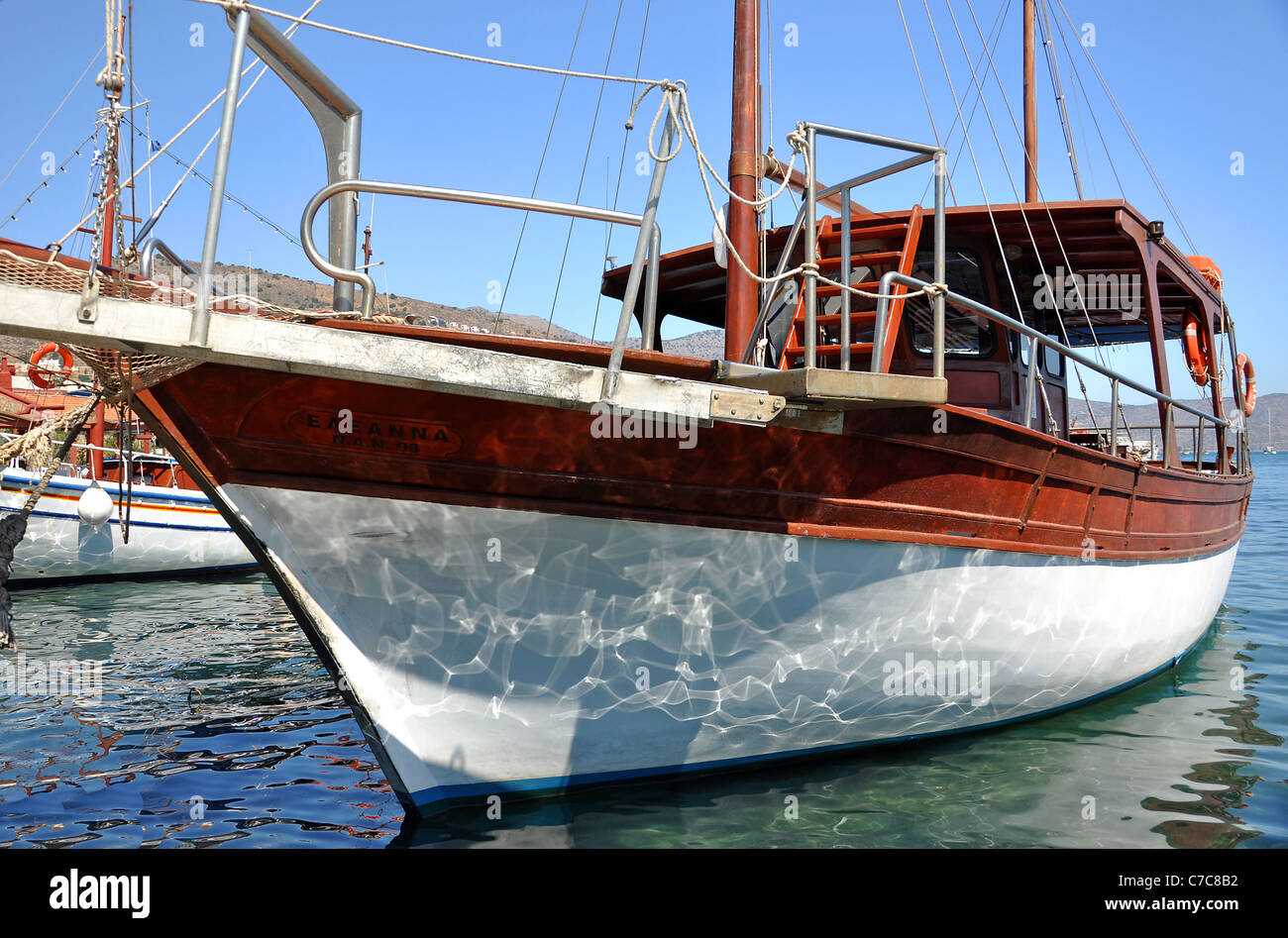 Boat moored at quayside with water reflecting on the hull Stock Photo ...
