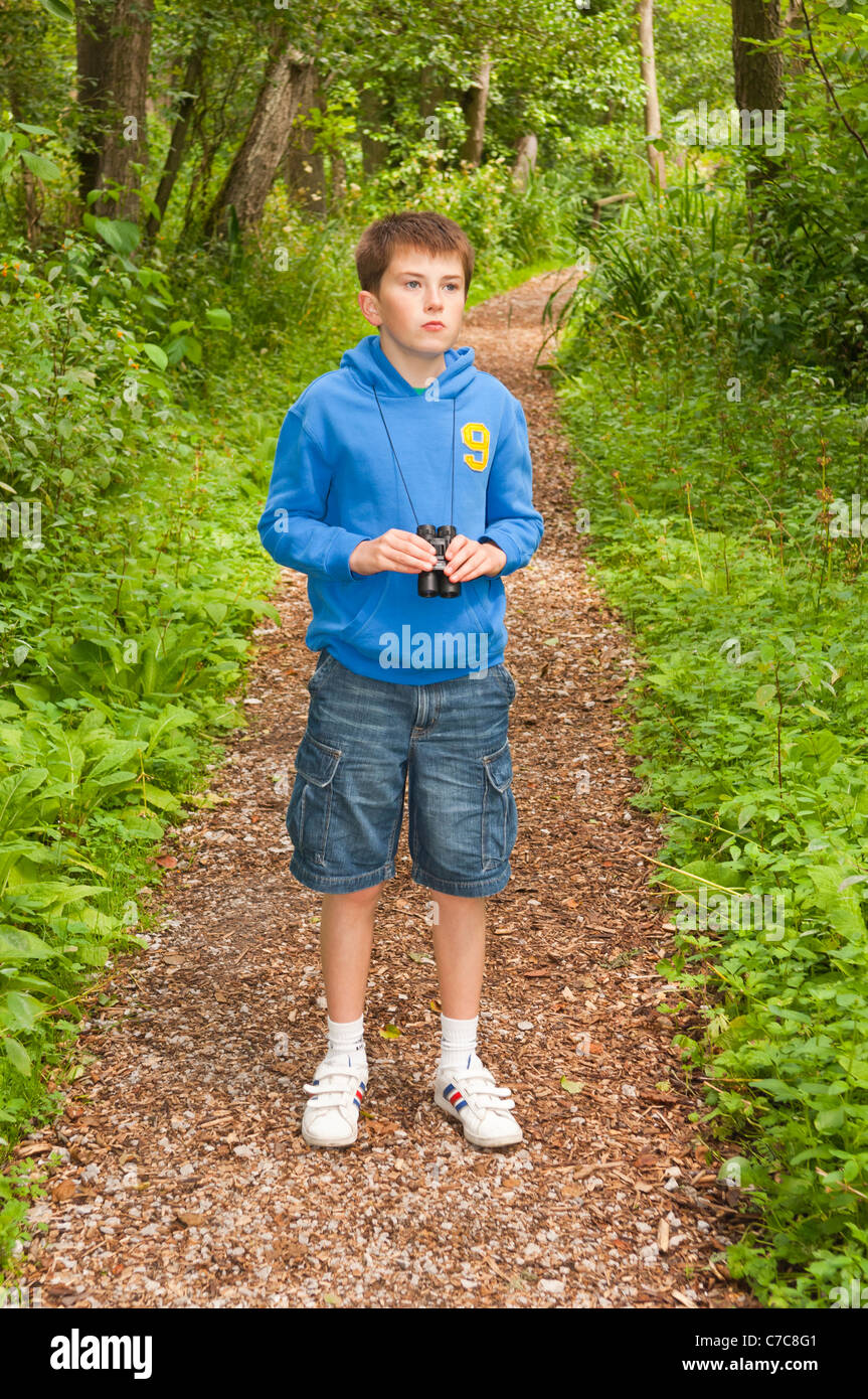 An eleven year old boy birdwatching with binoculars at Fairhaven water ...
