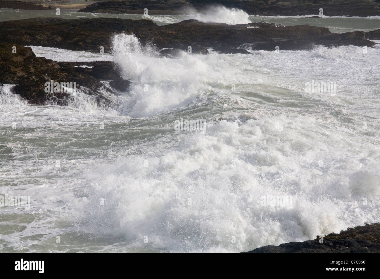 UK Storm force winds whipping up sea waves crashing over rocks Stock ...