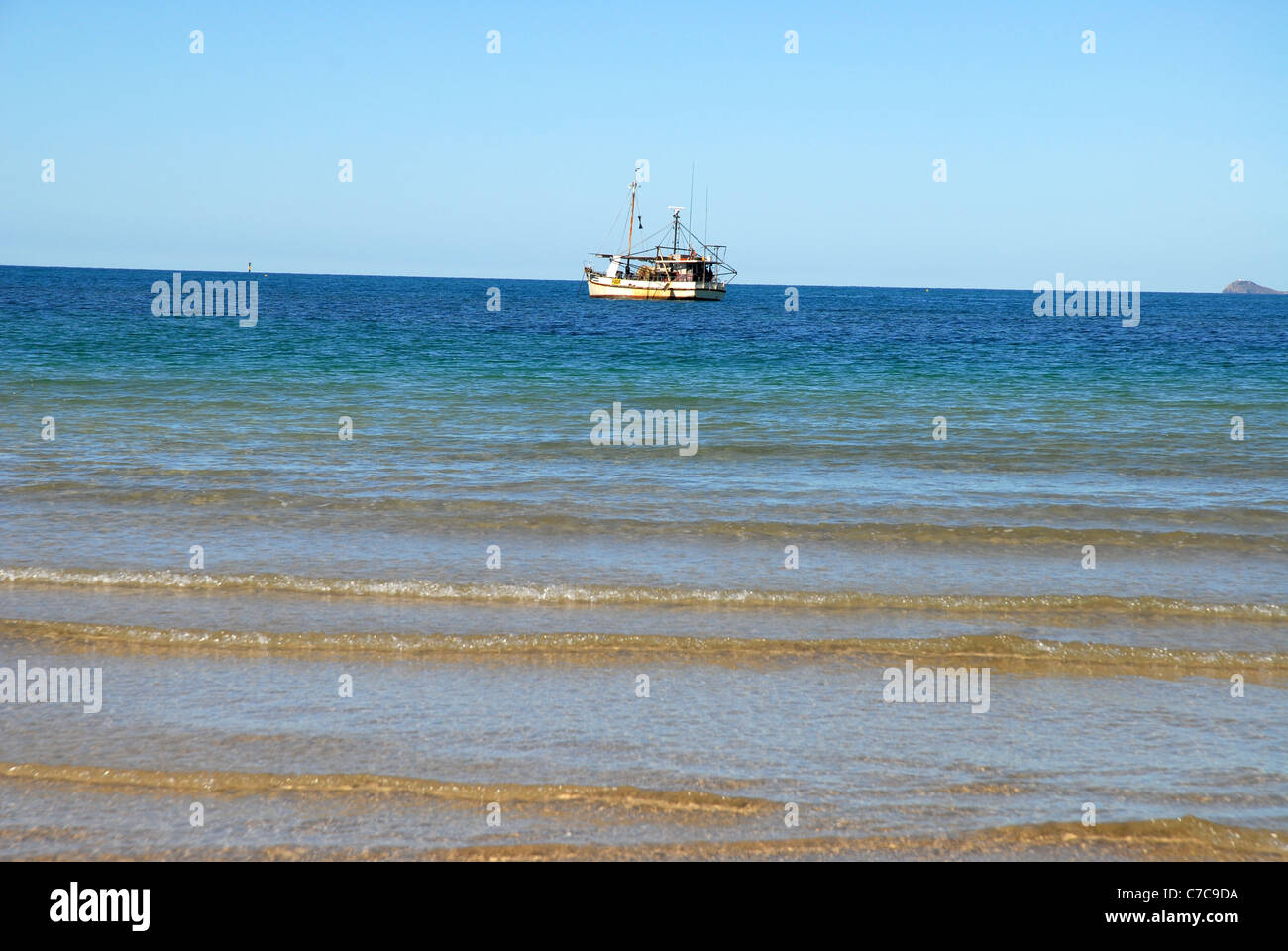 fishing boat anchored off a coral reef, Florence Bay, Magnetic Island ...
