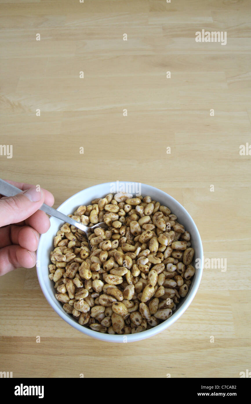 Caucasian Adult Male using a spoon to eat Sugar Puffs Breakfast Cereals ...
