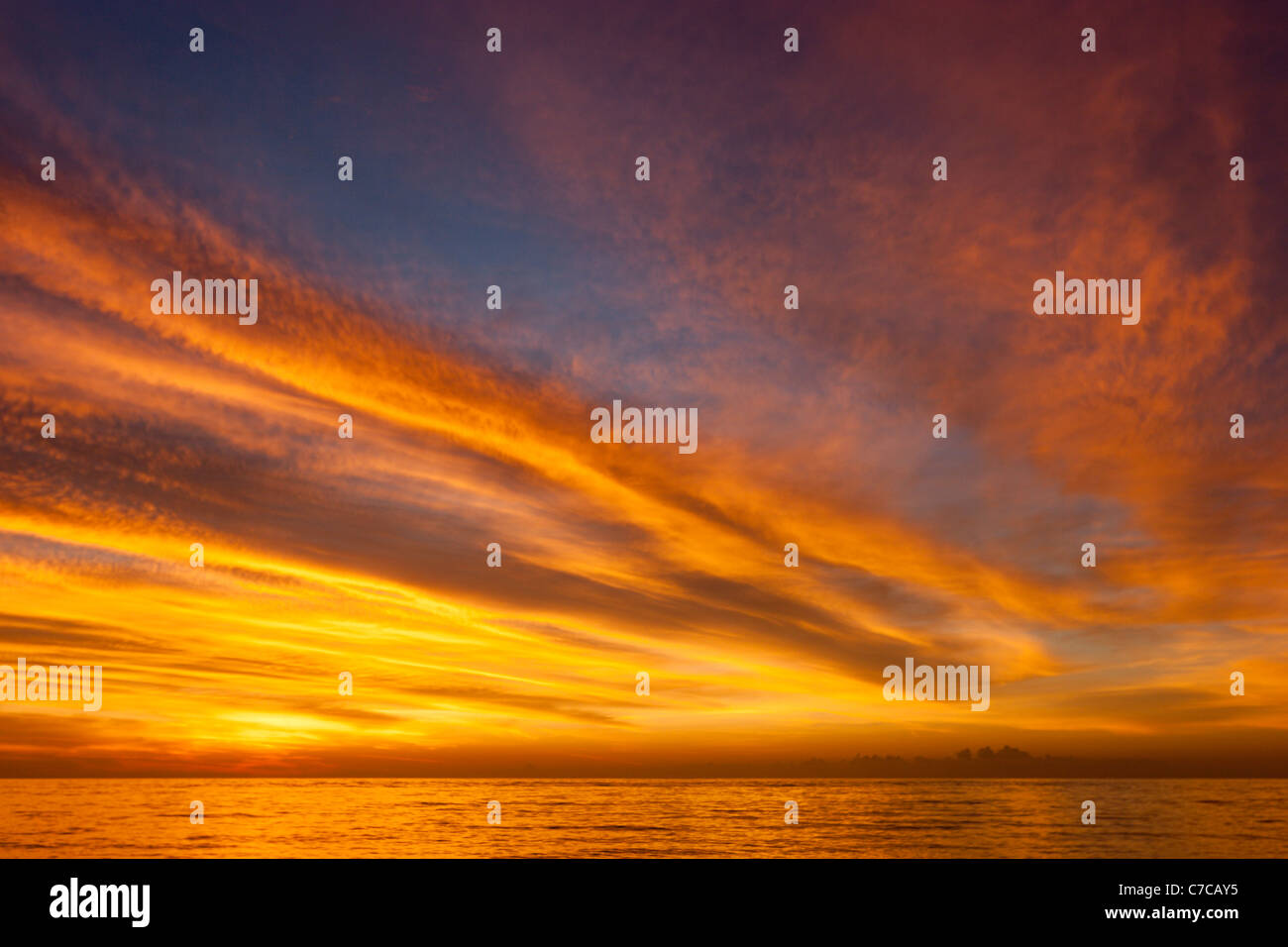 Gold sunset in southern Thailand at the sea with predominant yellow ...