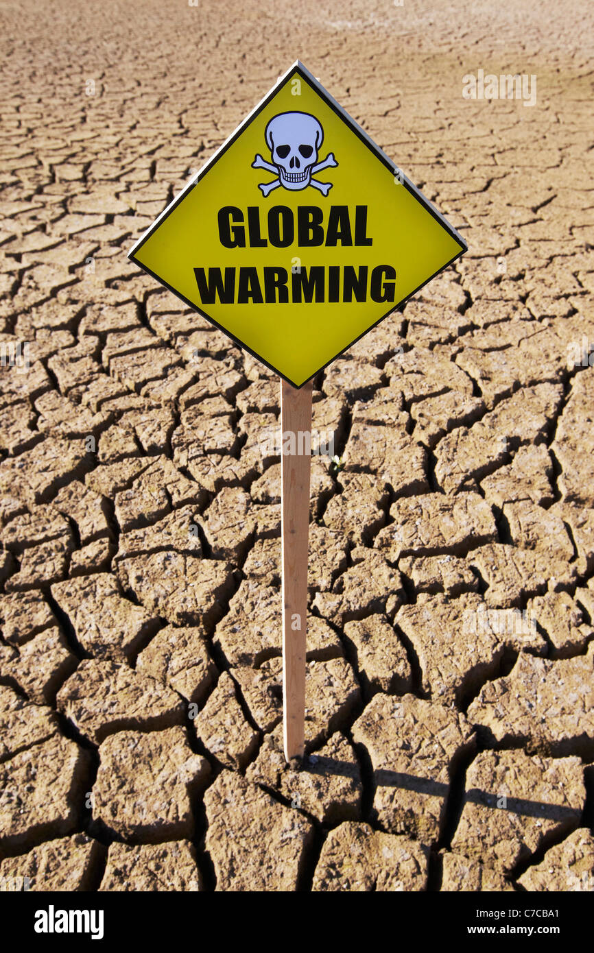 Global warming sign with skull and crossbones on cracked dried river ...