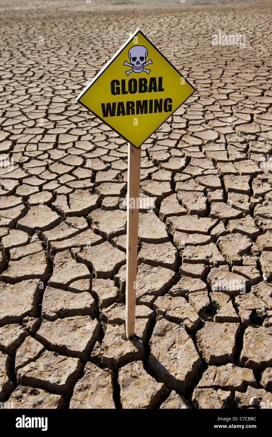 Global warming sign with skull and crossbones on cracked dried river ...
