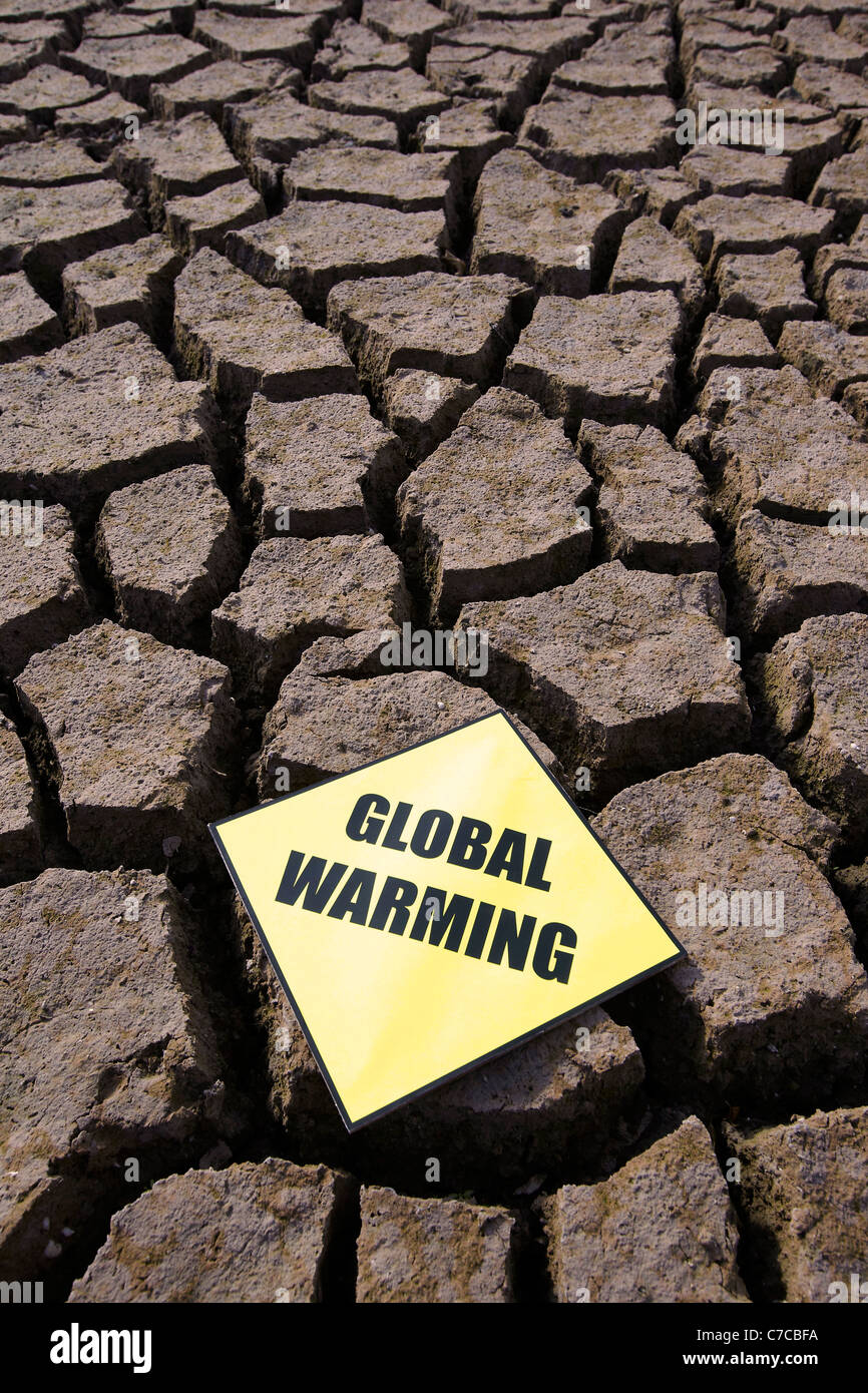Global warming sign on cracked dried river bed mud Stock Photo - Alamy