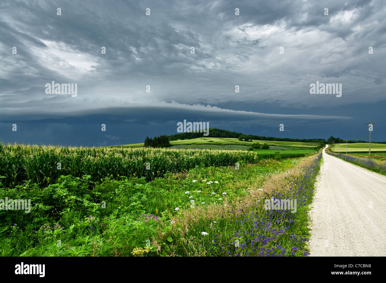 Storm Clouds Over a Country Road Stock Photo - Alamy