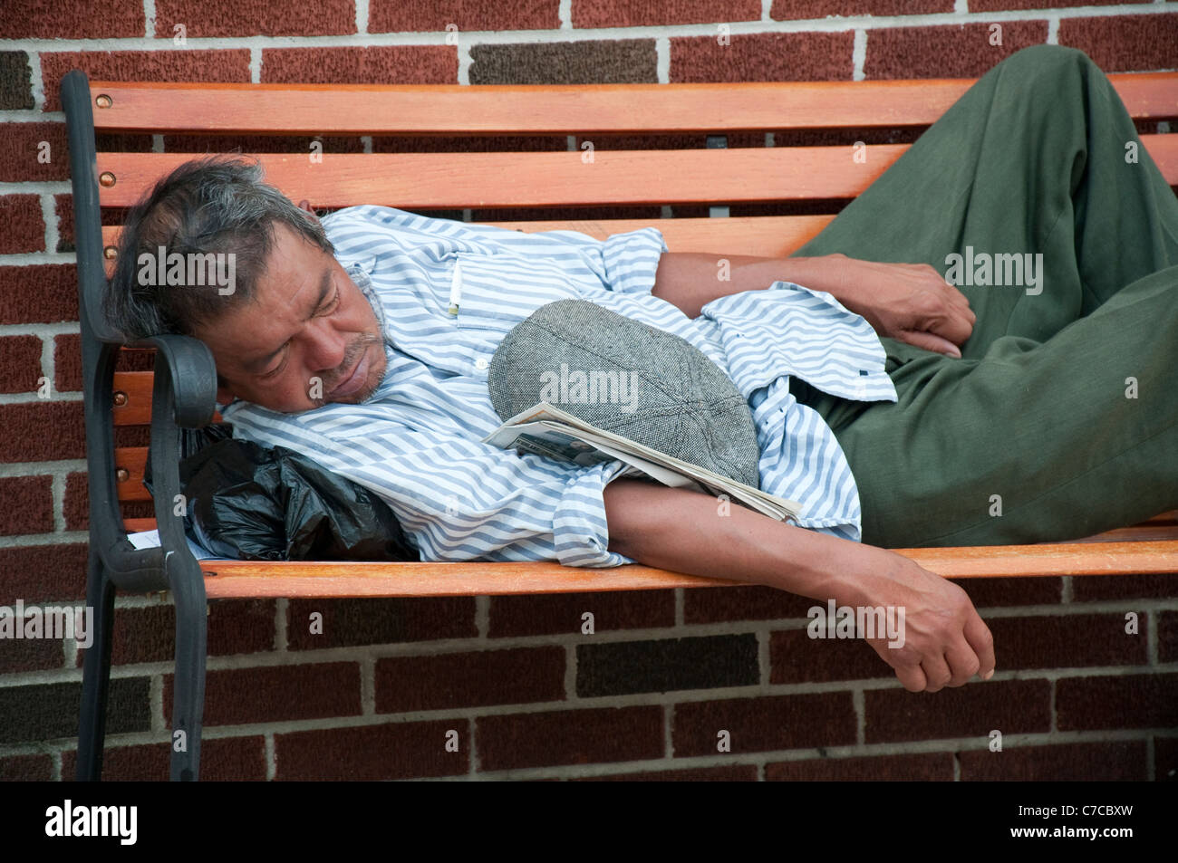 A man asleep on a bench in Baltimore Maryland USA Stock Photo - Alamy