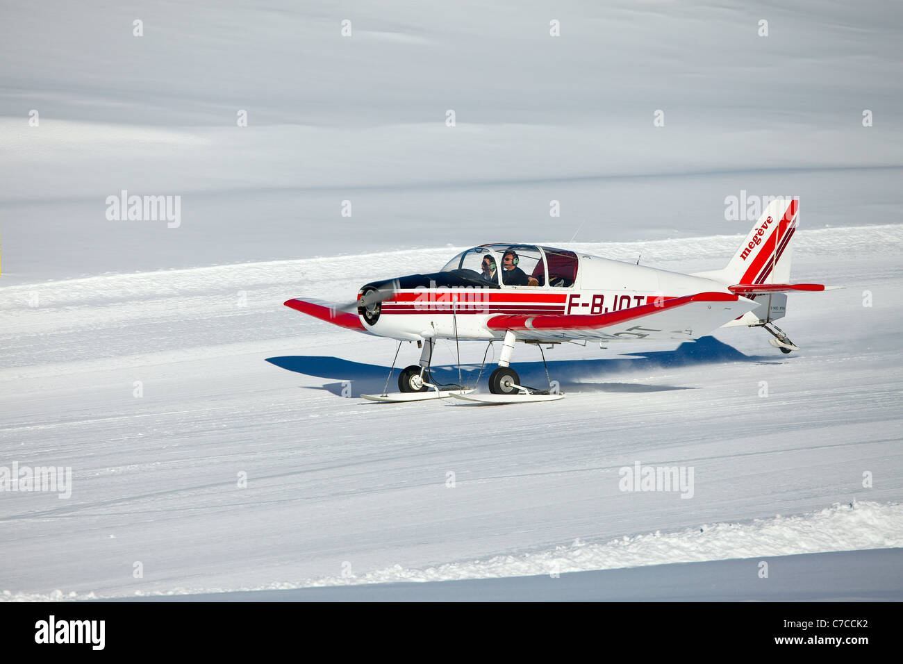 Small plane landing on snow Stock Photo - Alamy