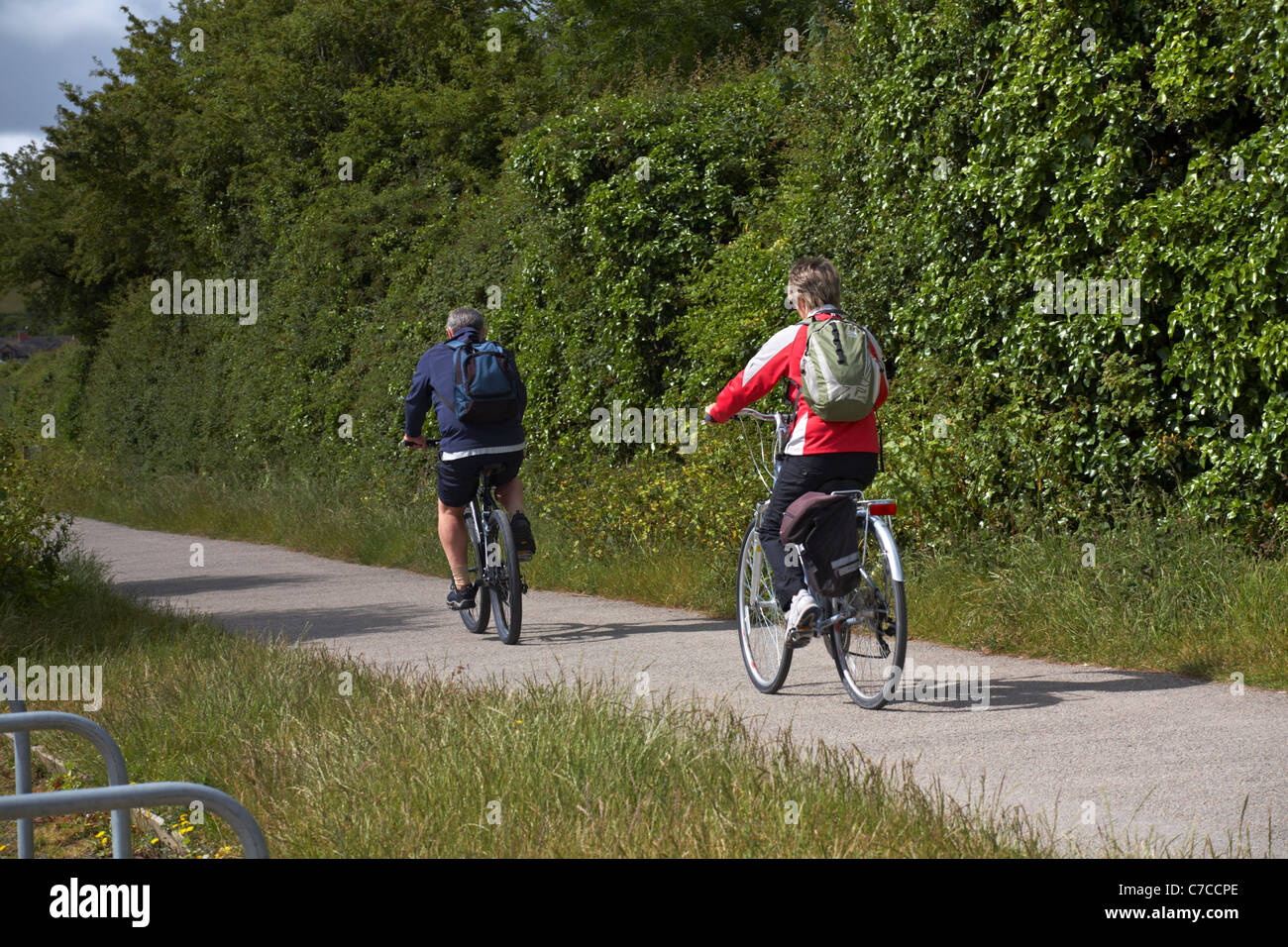 Couple cycling along cycle track Camel Trail at Padstow, Cornwall UK in ...
