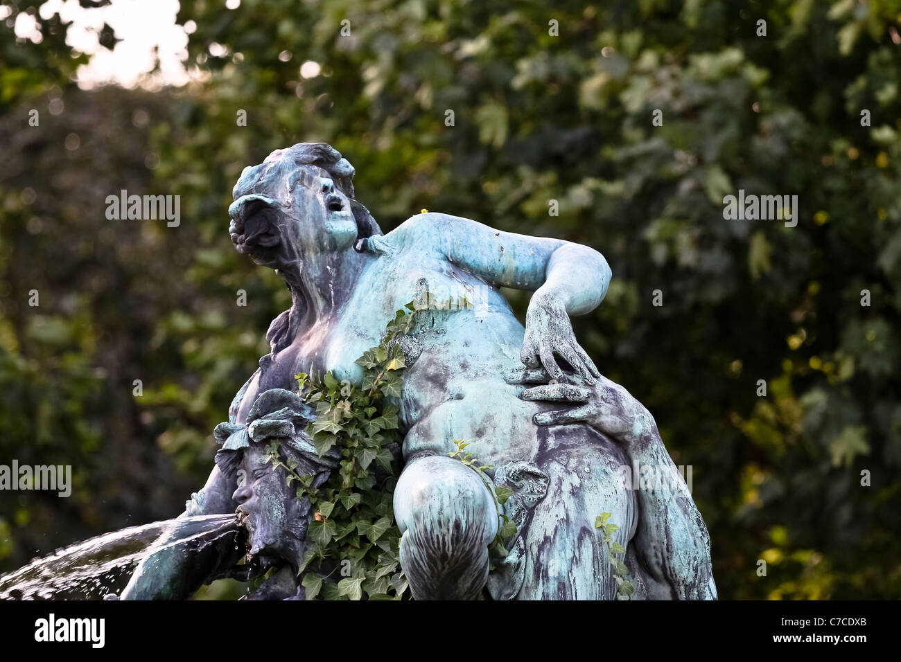 A scared looking sculpture on a fountain in a park in Vienna Stock ...