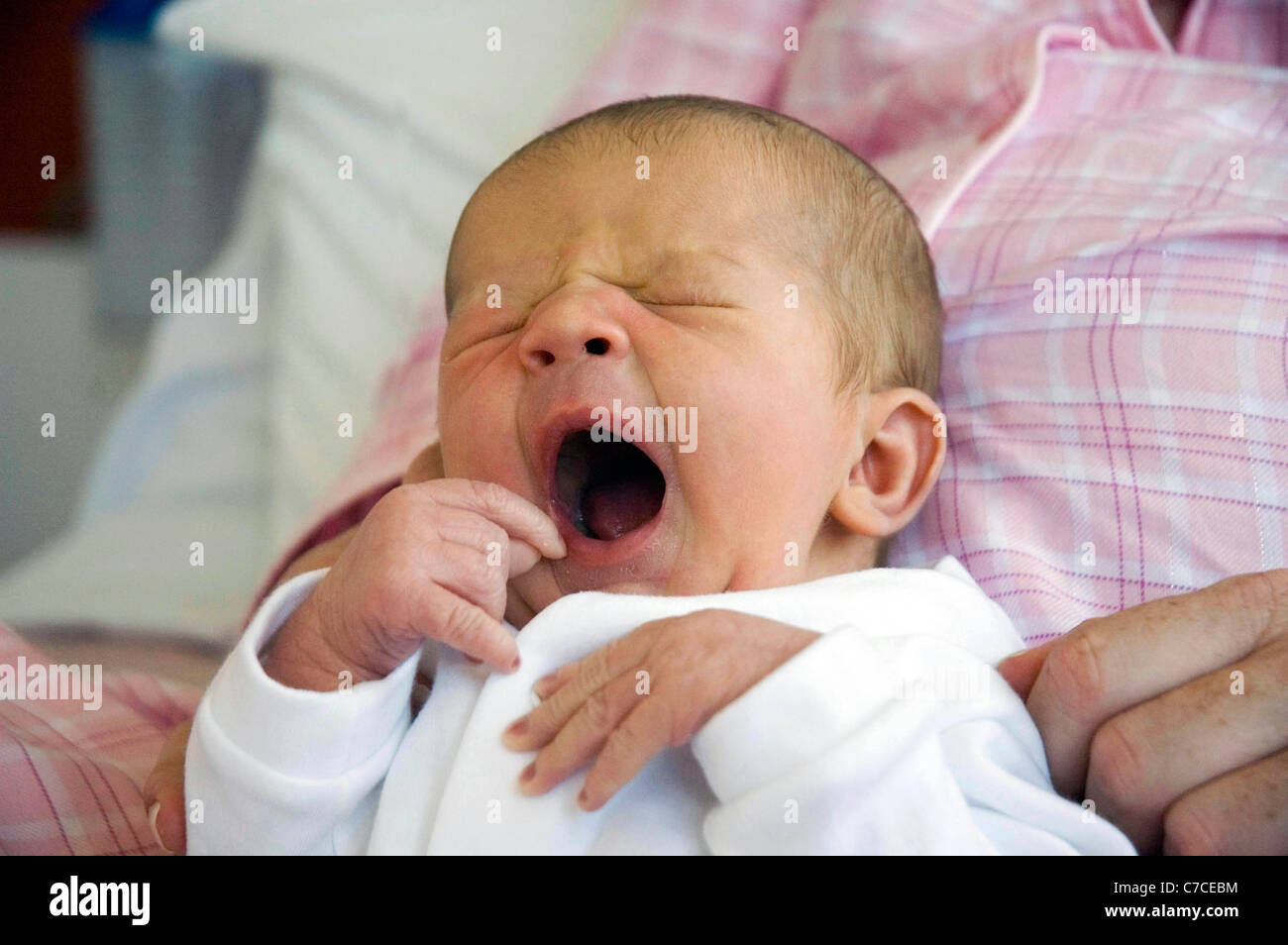Newborn baby yawning the morning after being born Stock Photo - Alamy
