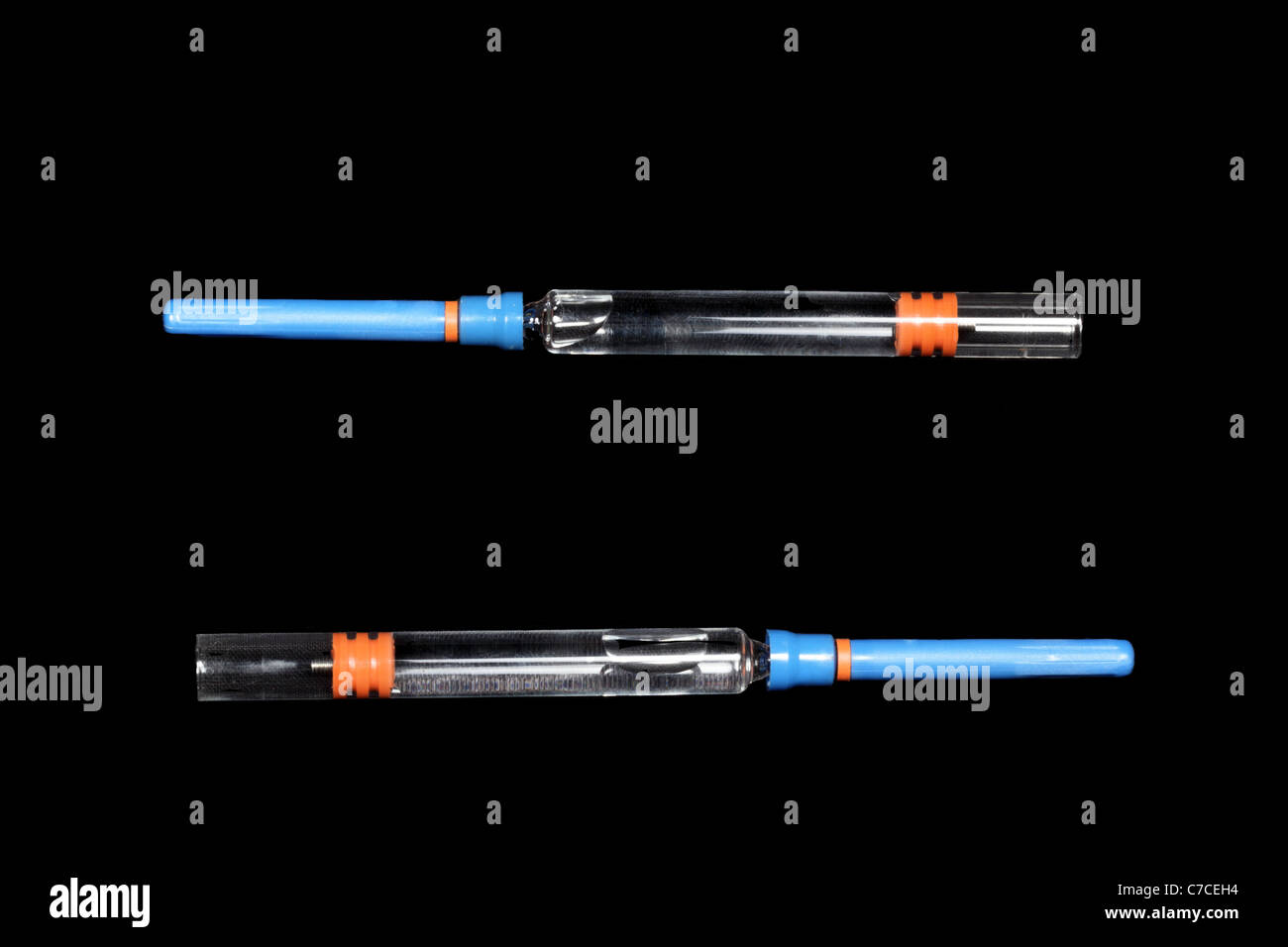 Single dose injection syringes over a black background Stock Photo - Alamy