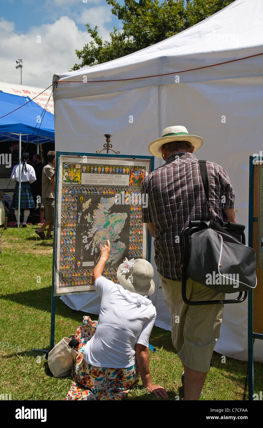Two people looking at an old ancestral map of Scotland at the Waipu ...