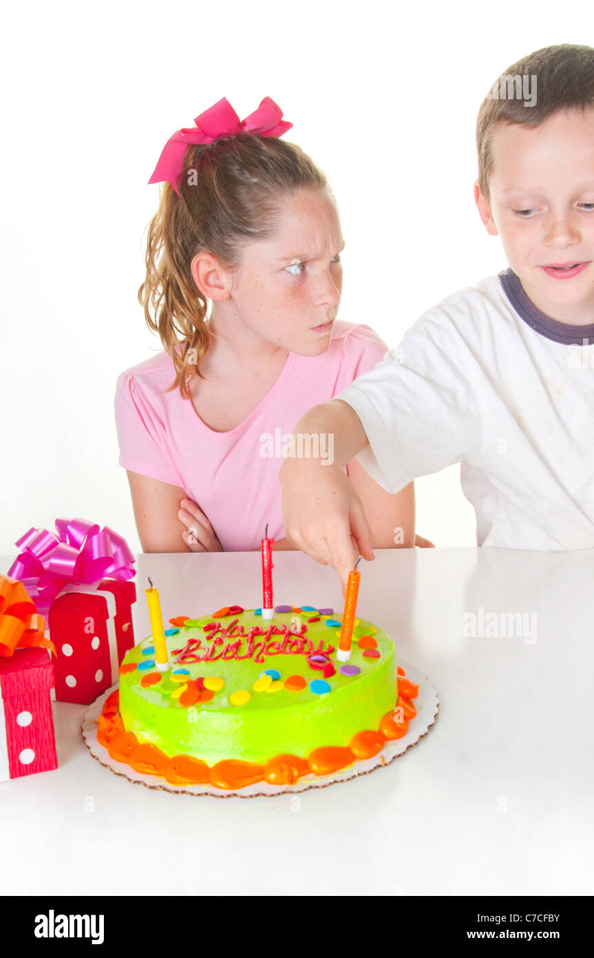 Boy sneaking taste of icing Stock Photo - Alamy
