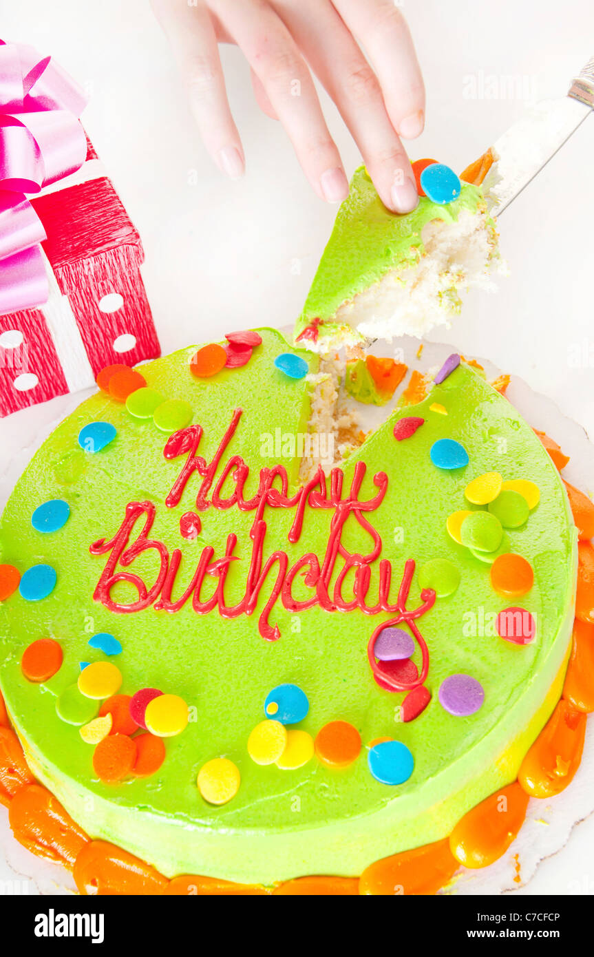Cutting slice of birthday cake Stock Photo - Alamy