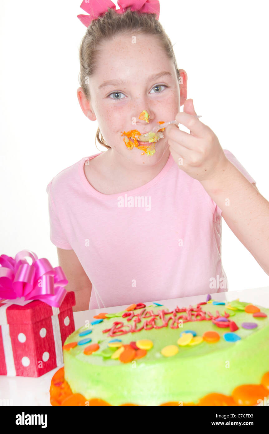 Girl eating birthday cake Stock Photo - Alamy
