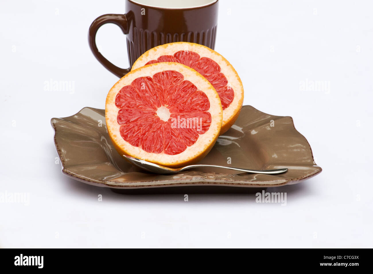 Fresh ruby grapefruit cut in halves on white background Stock Photo - Alamy