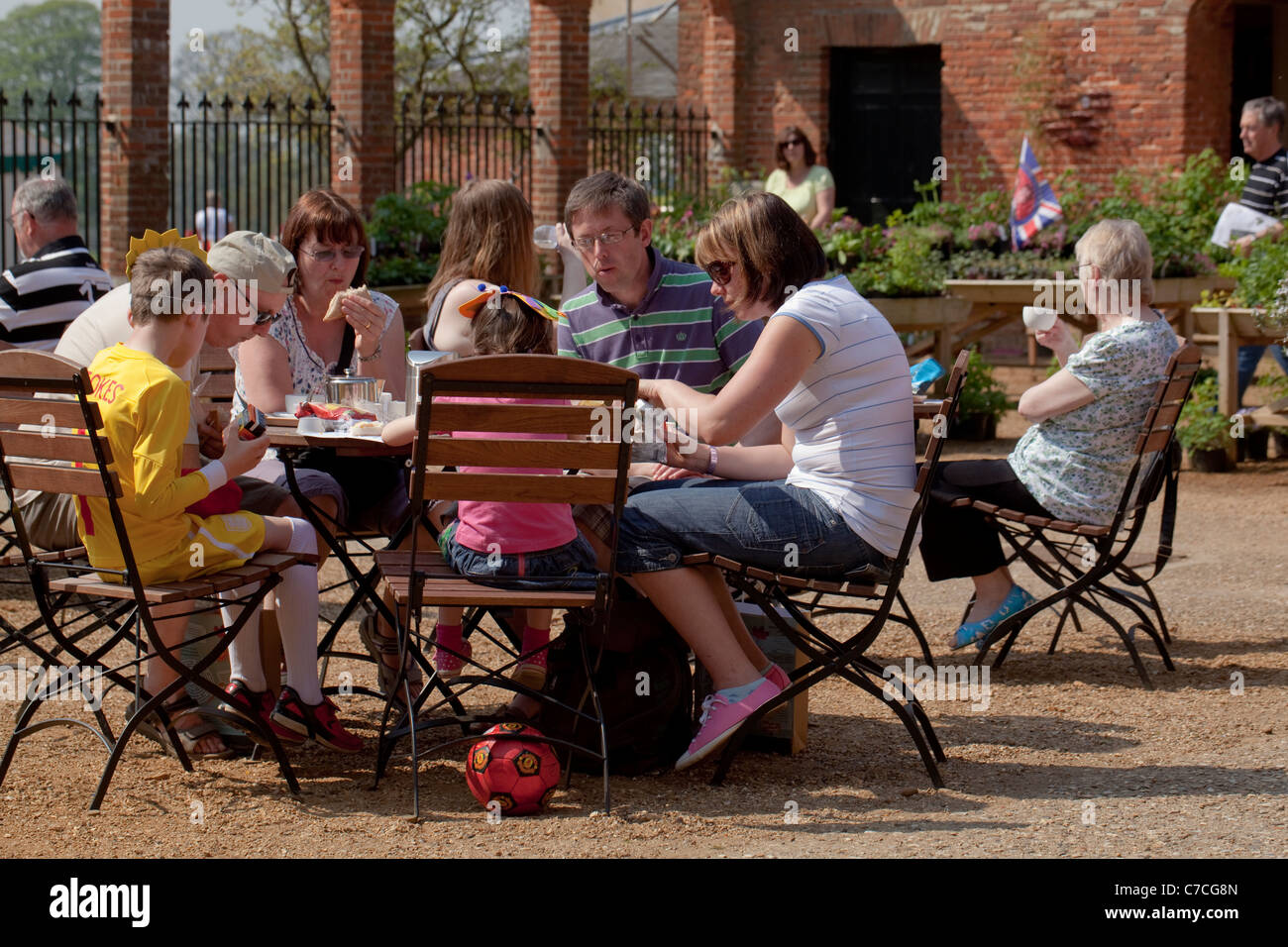 Family, friends lunch time picnic. Outdoors Visitor Centre. Summer ...