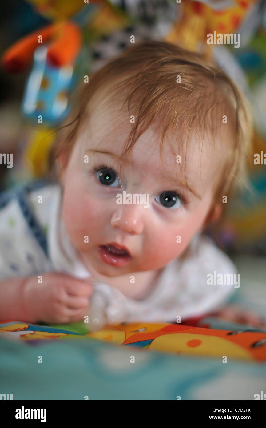 happy smiley cute baby playing with dummy on her play mat Stock Photo ...
