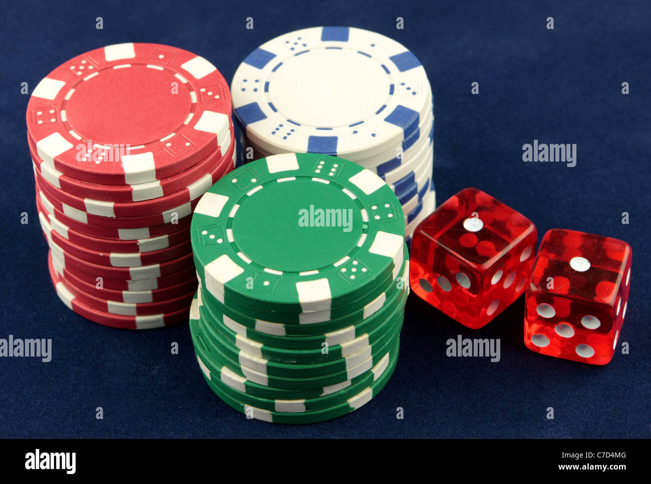 Gambling chips and dice on a blue velvet table Stock Photo - Alamy