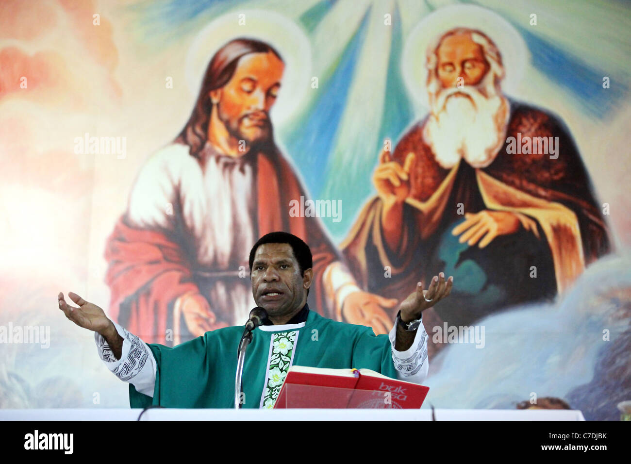 Roman catholic priest preaching from the bible at the altar, Papua New ...