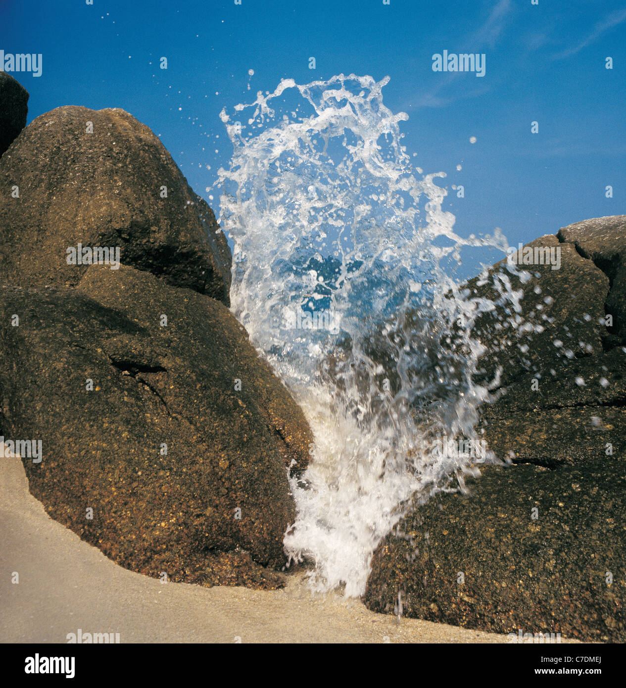a wave splashed between two rocks Stock Photo - Alamy