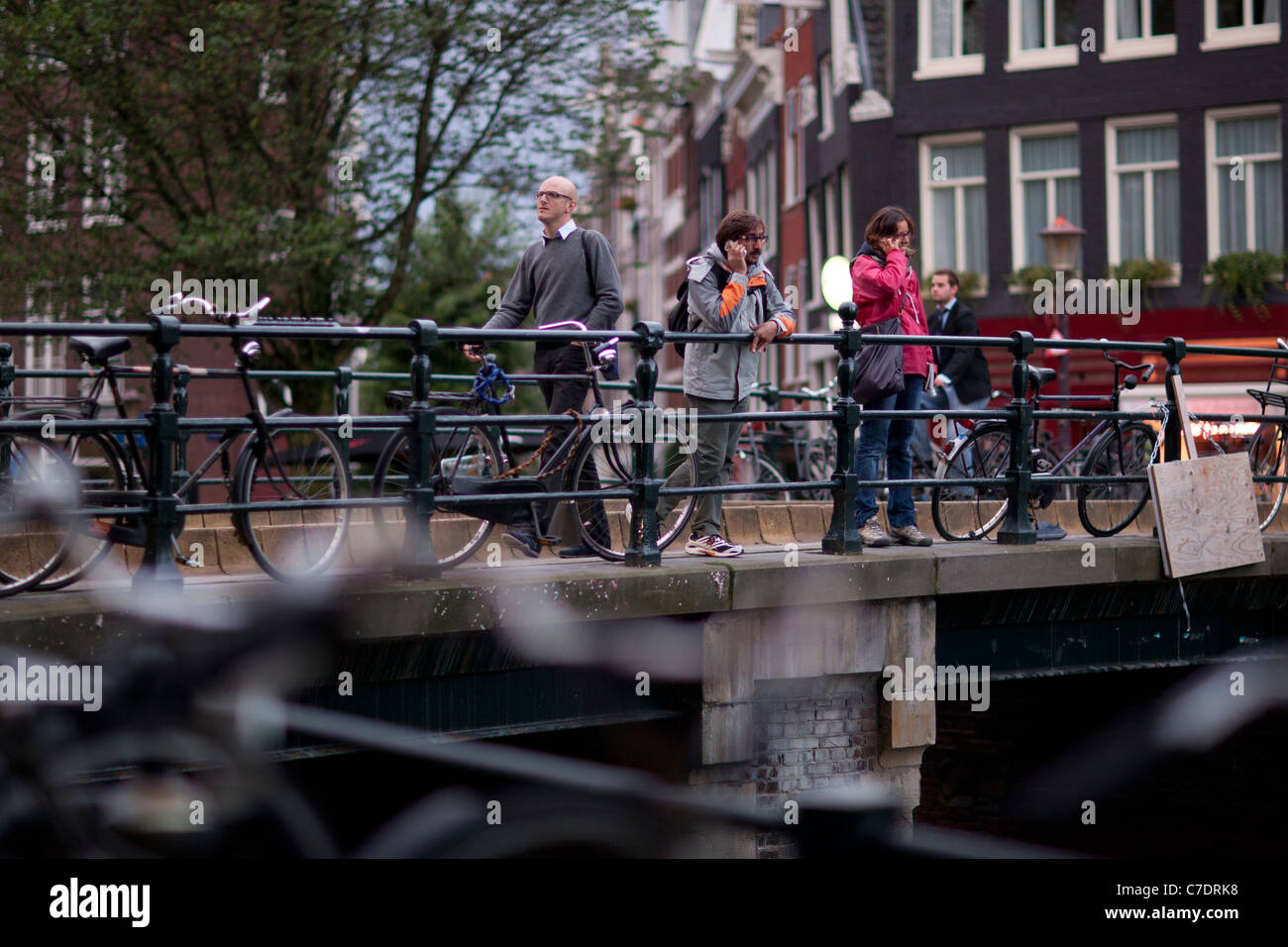 People crossing a bridge in Amsterdam Stock Photo - Alamy