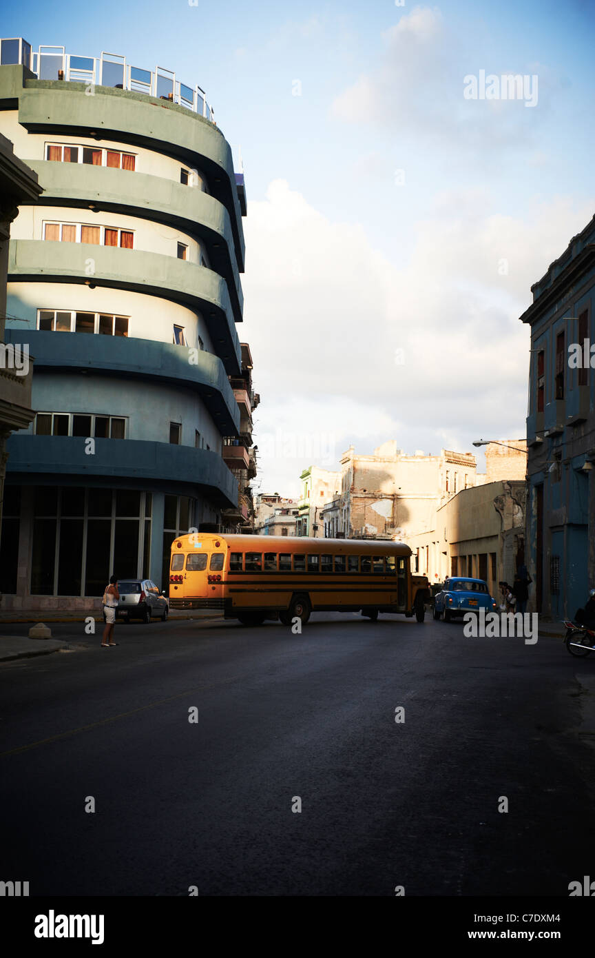Havan street scene Cuba yellow school bus dusk Stock Photo - Alamy