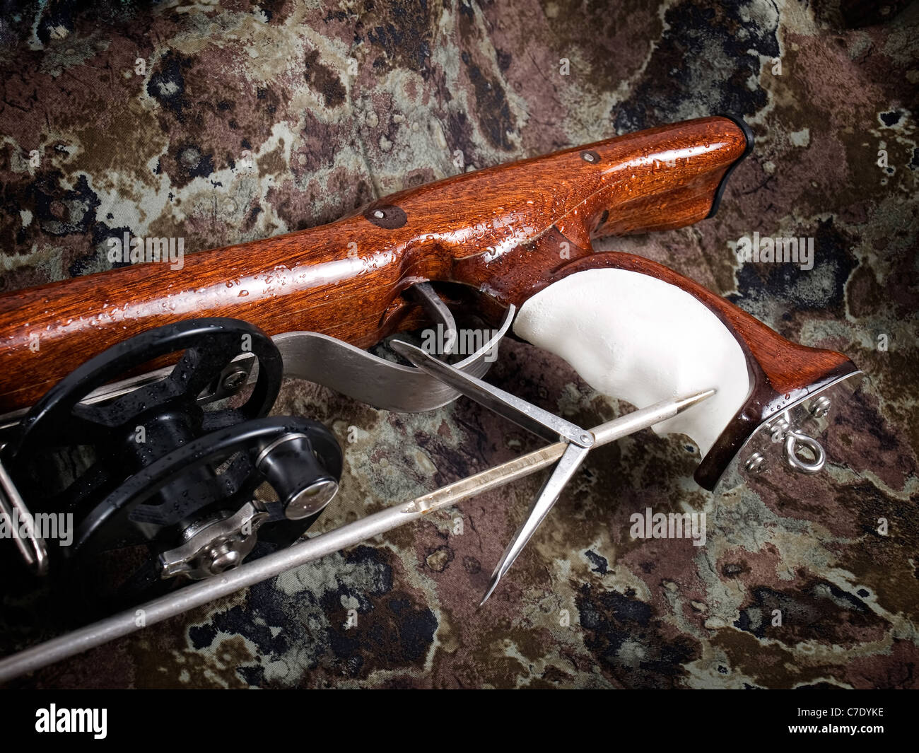 Wooden spear gun with harpoon on a mimetic background Stock Photo - Alamy