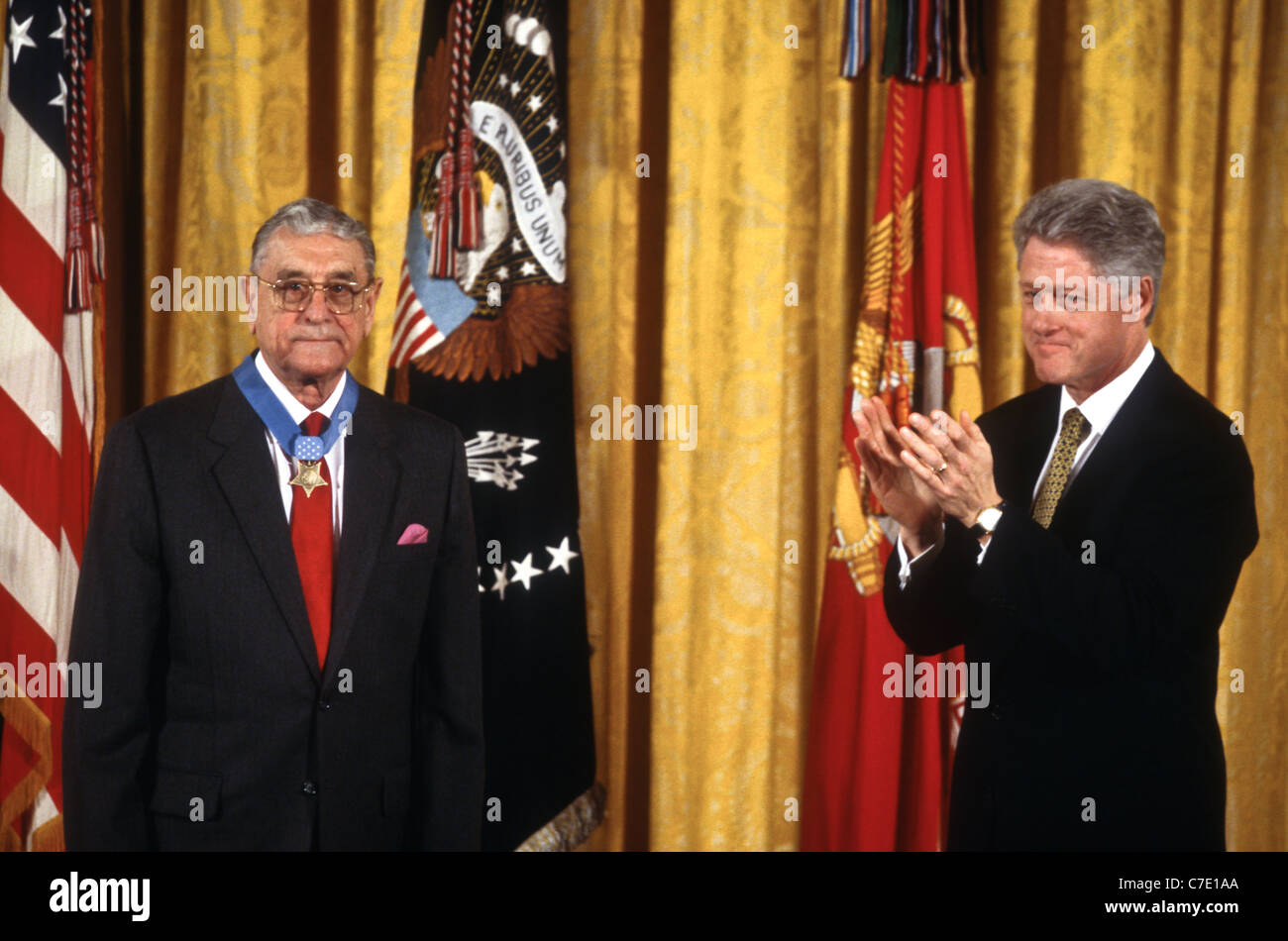 U.S. President Bill Clinton presents retired Marine Major General James ...