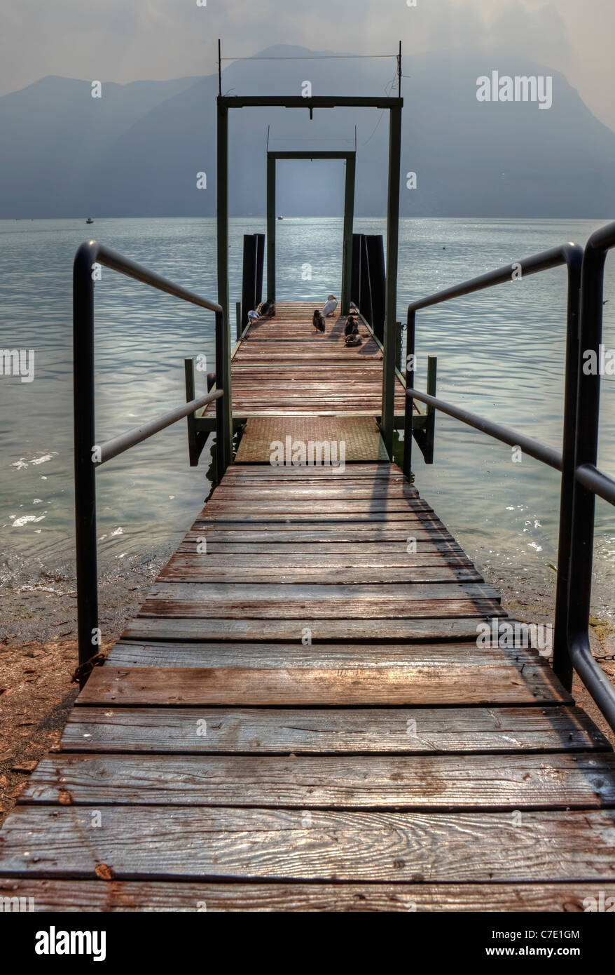 lonely boat dock on Lake Lugano with ducks Stock Photo - Alamy