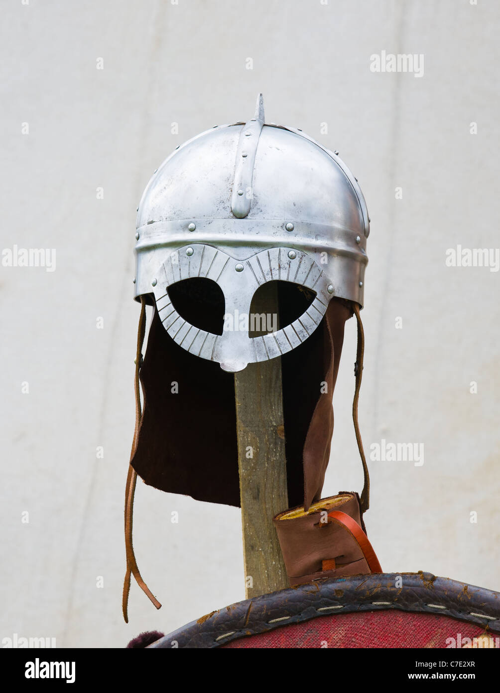 Steel helmet hanging on a wooden pole against a white tent of warriors ...
