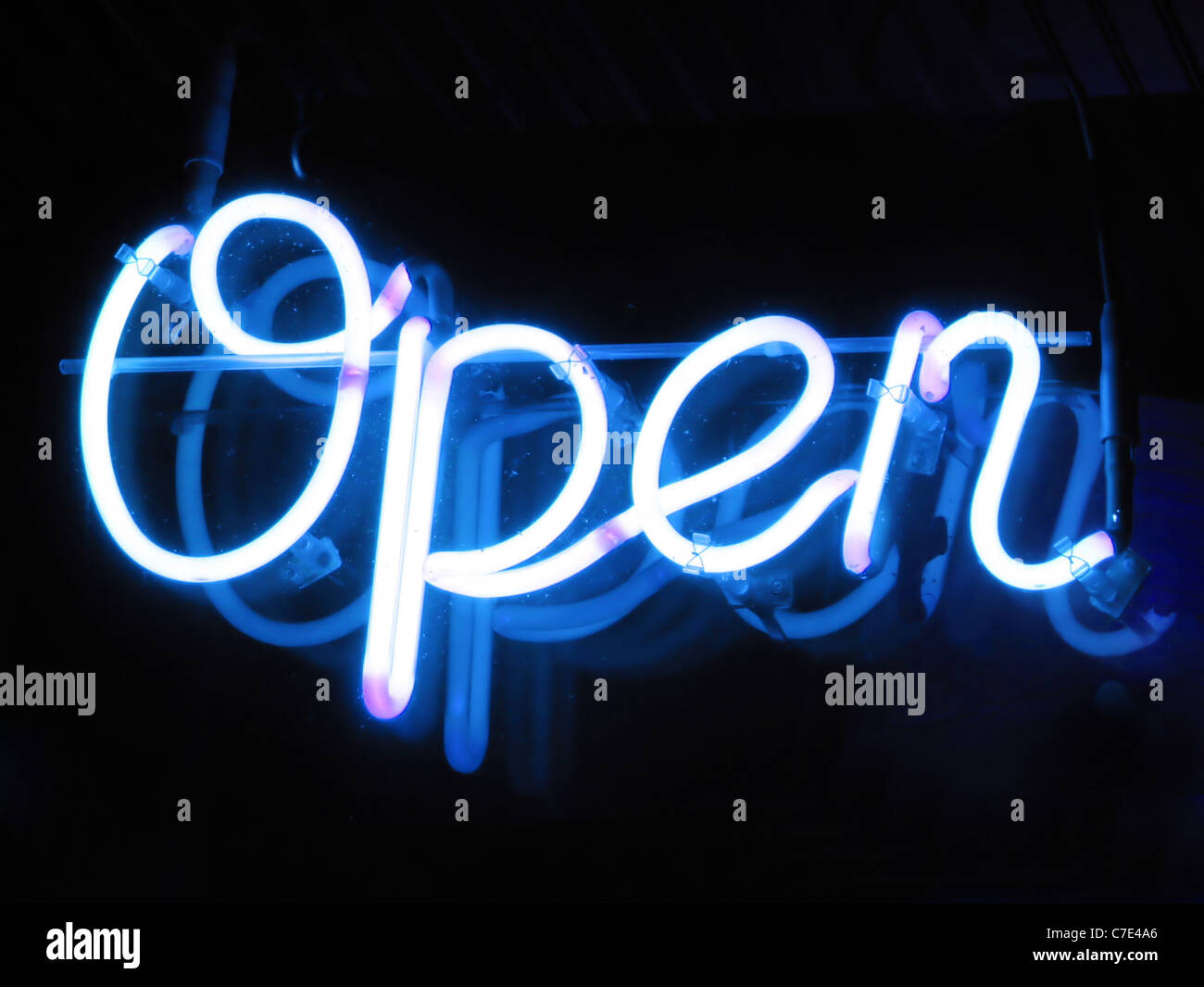 A neon "open" sign glowing blue in the window of a restaurant Stock ...