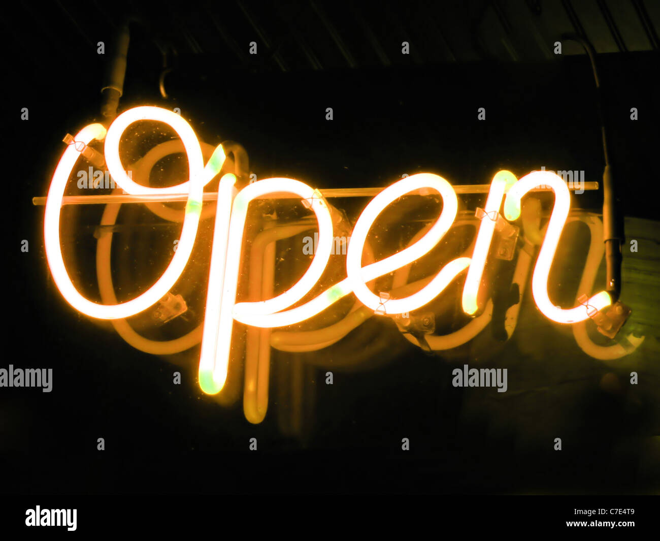 A neon orange OPEN sign glowing in the window of a restaurant Stock ...