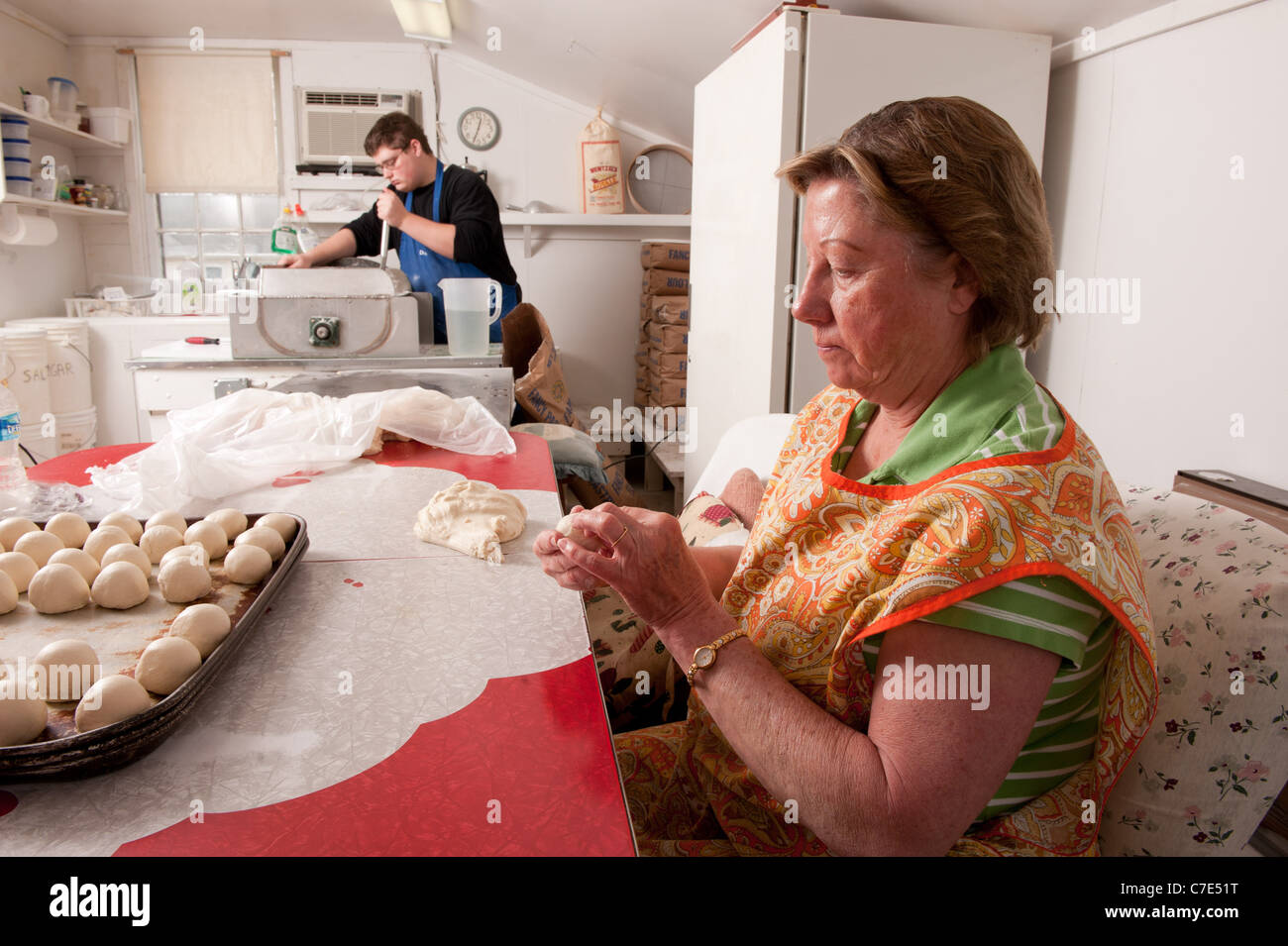 people rolling dough in the process of making beaten biscuits Stock ...