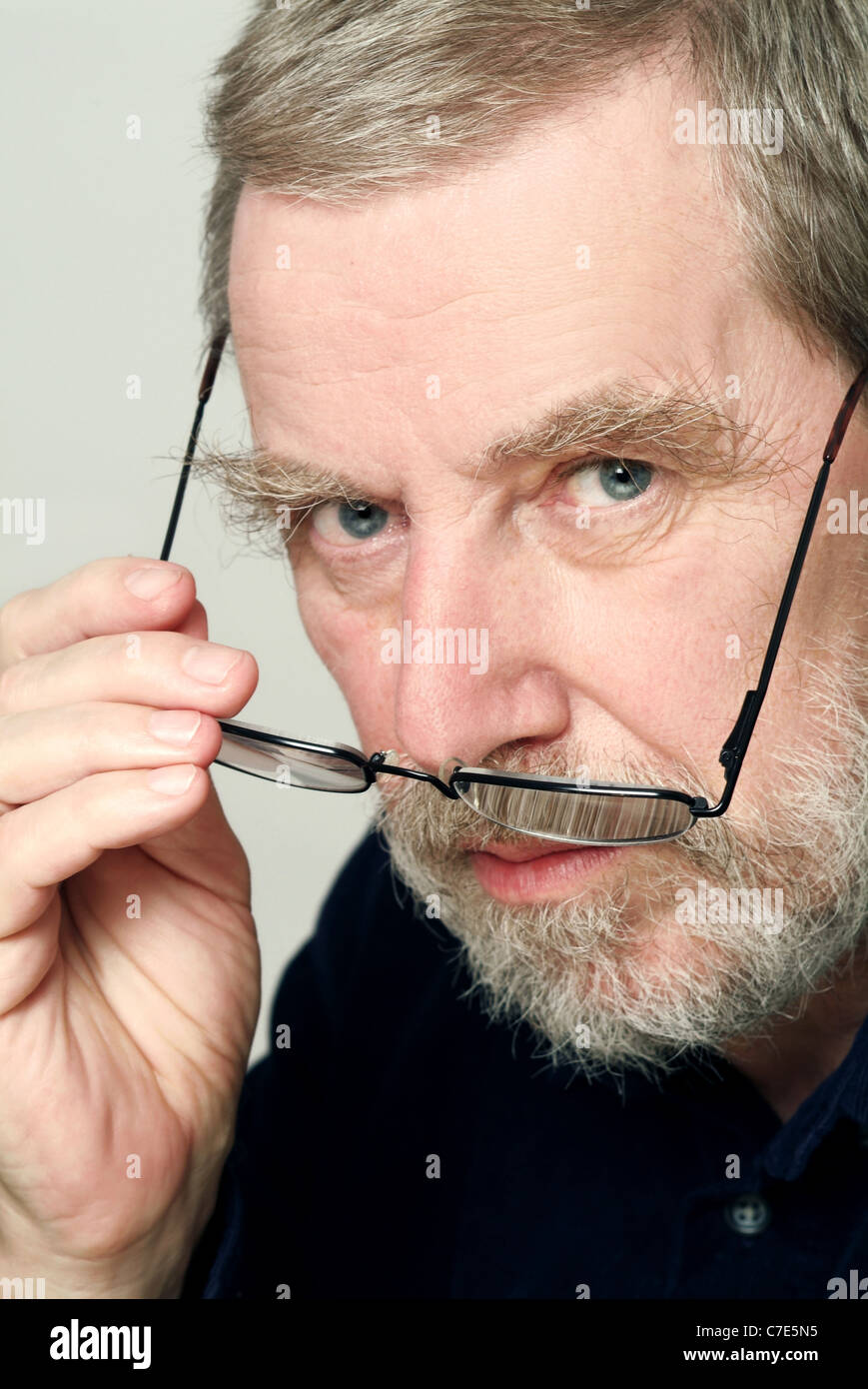 Skeptical man with glasses Stock Photo - Alamy