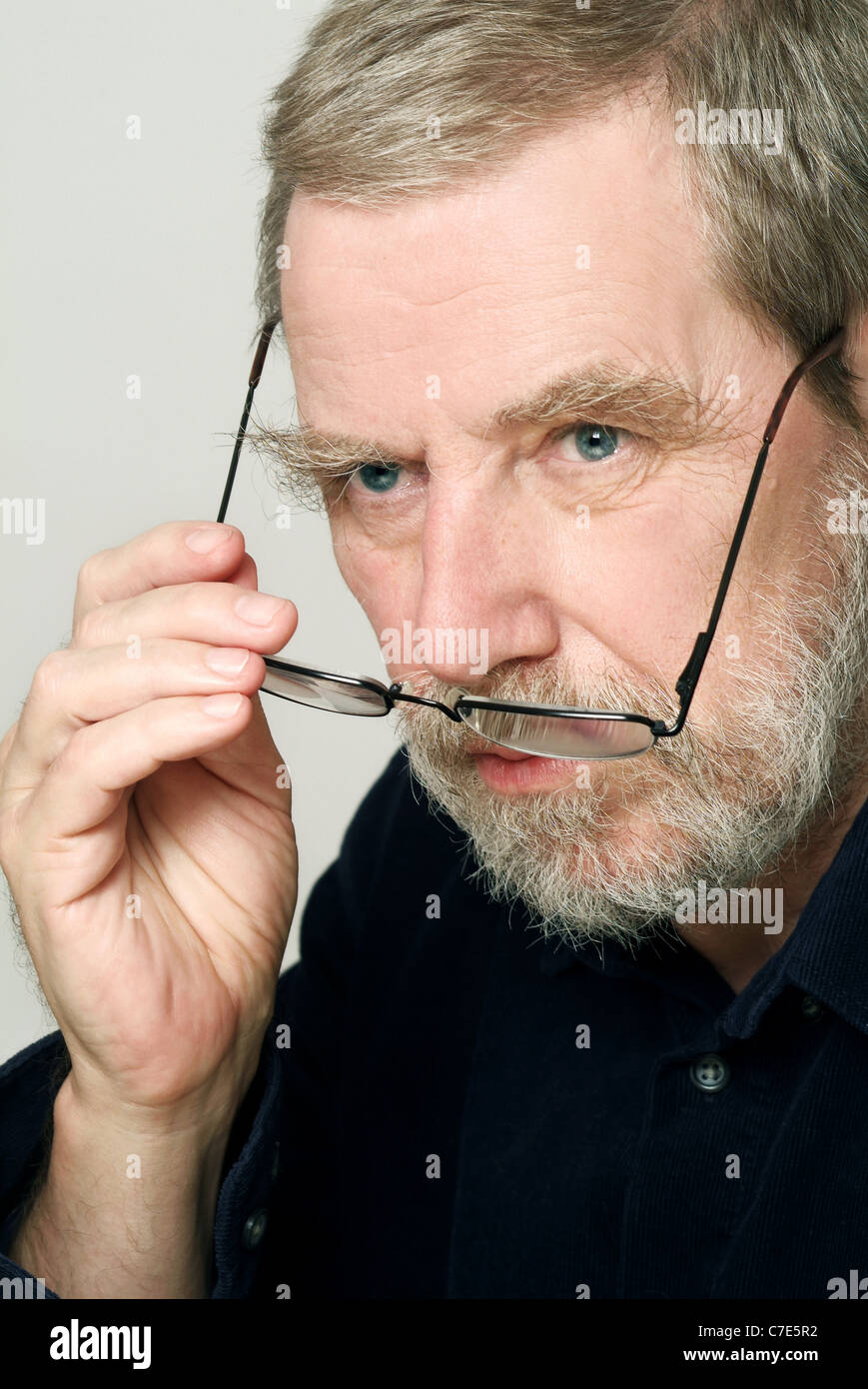 Skeptical man with glasses Stock Photo - Alamy