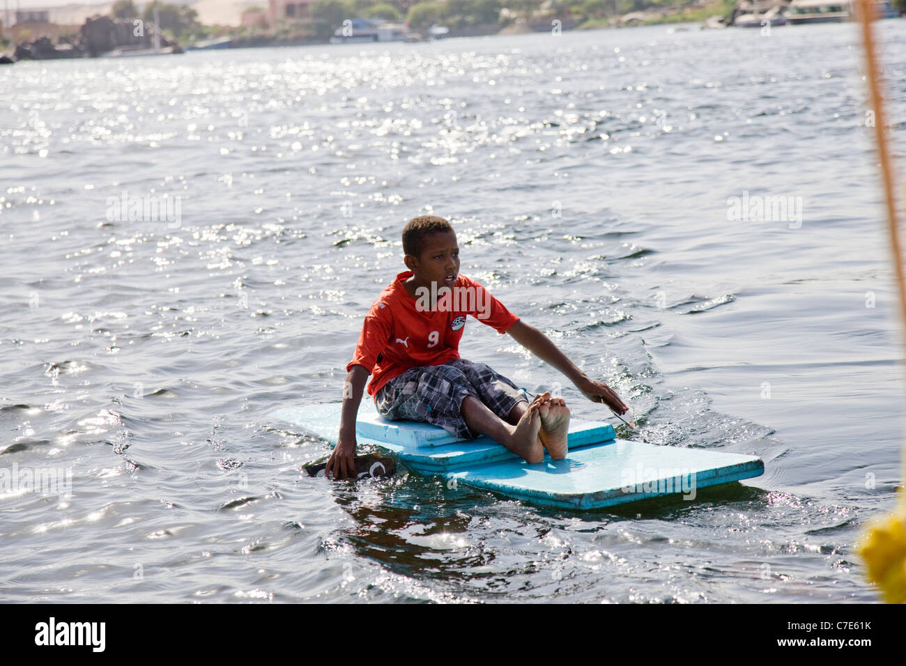 Little boy floating on an improvised raft on the River Nile Stock Photo ...