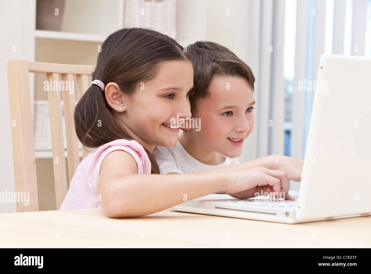 Young boy & girl children using laptop computer at home Stock Photo - Alamy
