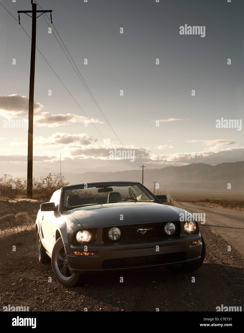 Ford Mustang in desert sunset landscape upright Mojave Desert ...