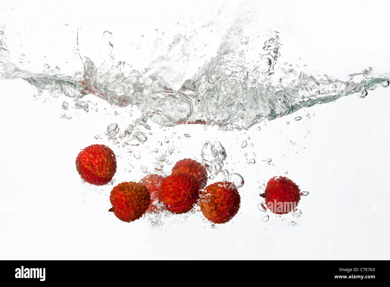 Lychee Splashing into Water Stock Photo - Alamy