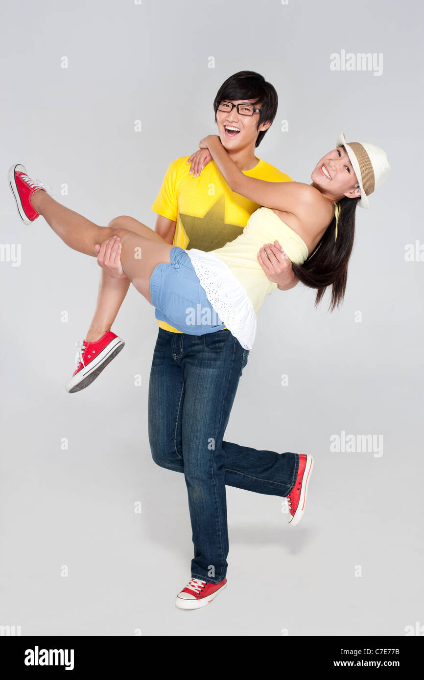 Young Man Carrying Girlfriend Stock Photo - Alamy