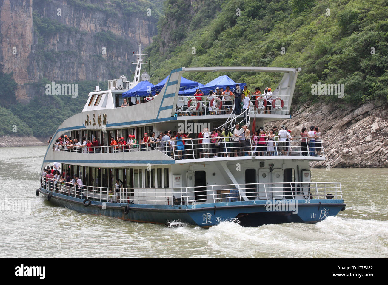 Tourist boat, loaded with passengers, cruising through Lesser Three ...
