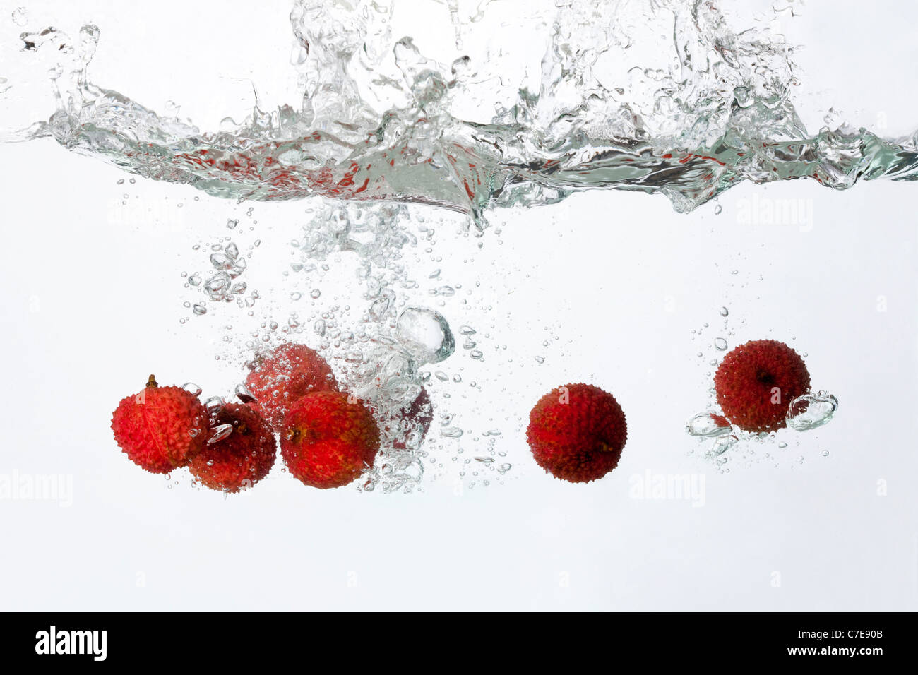 Lychee Splashing into Water Stock Photo - Alamy